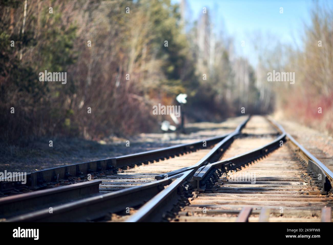 Railway fork with out of focus hand-operated railroad switch, with ...