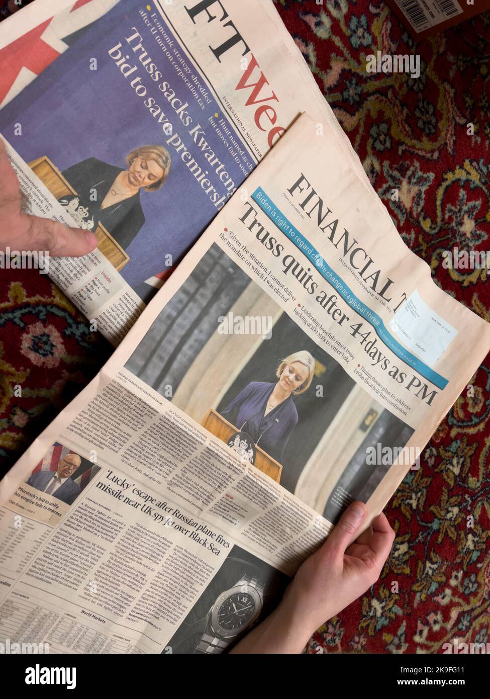 LONDON, ENGLAND - OCTOBER 20: Curious woman reading in living room ...