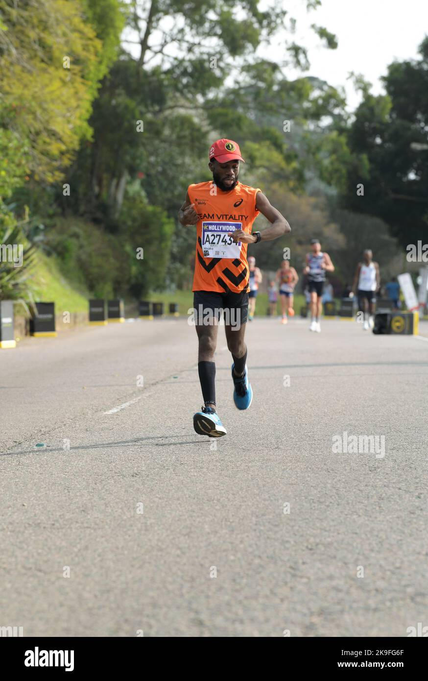 Fit adult man running 95th Comrades Marathon, looking at watch ...