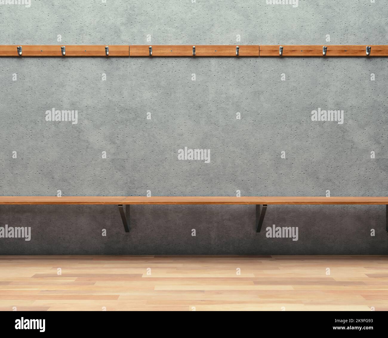 A clothes hanging rack above an empty wooden bench against a concrete ...