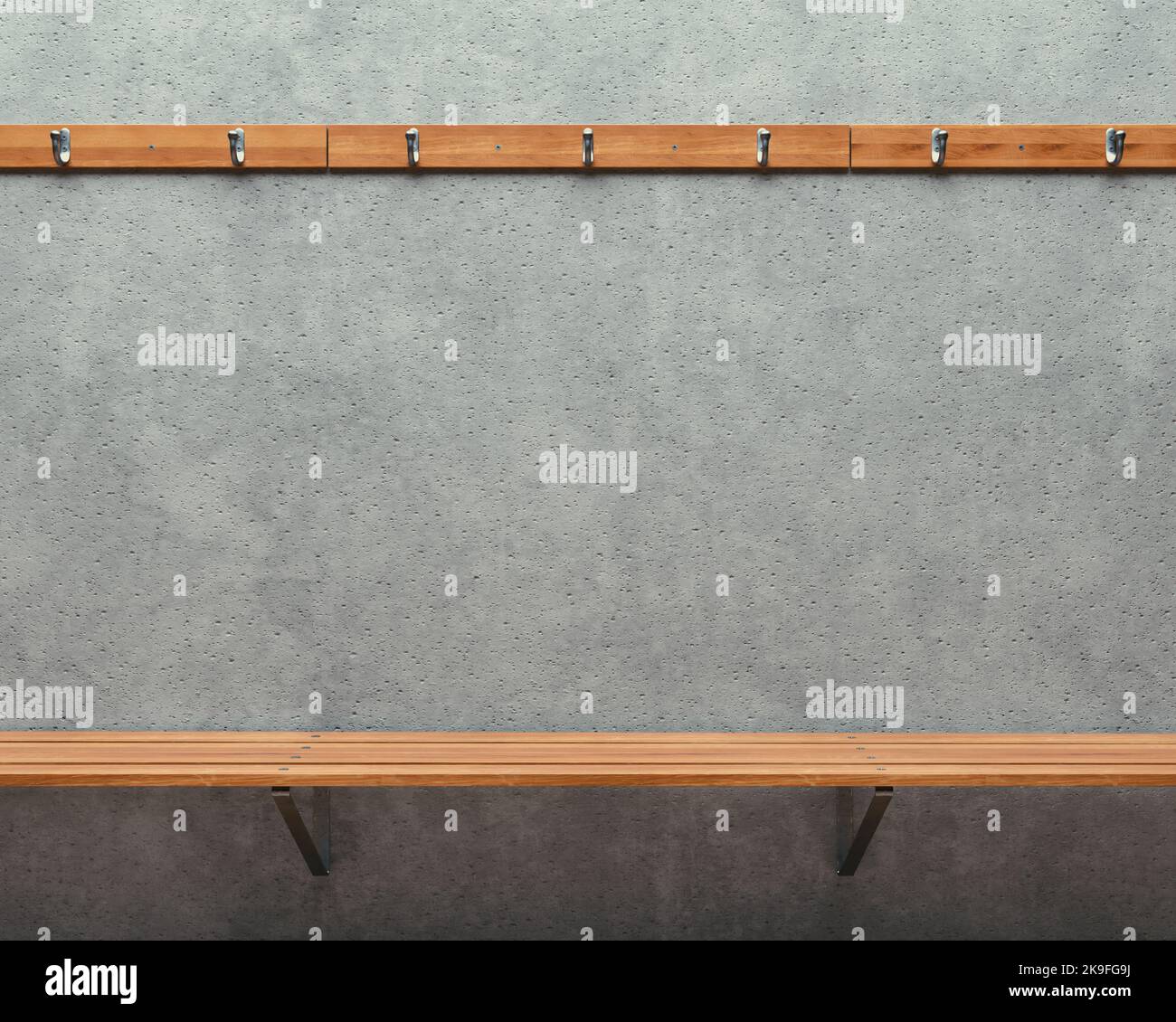 A clothes hanging rack above an empty wooden bench against a concrete ...