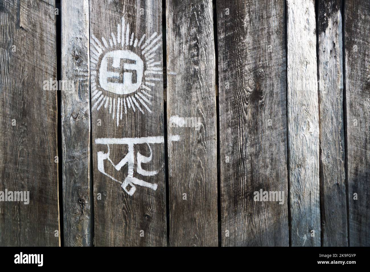 Traditional Nepali religious symbol painted on the wall of a village ...