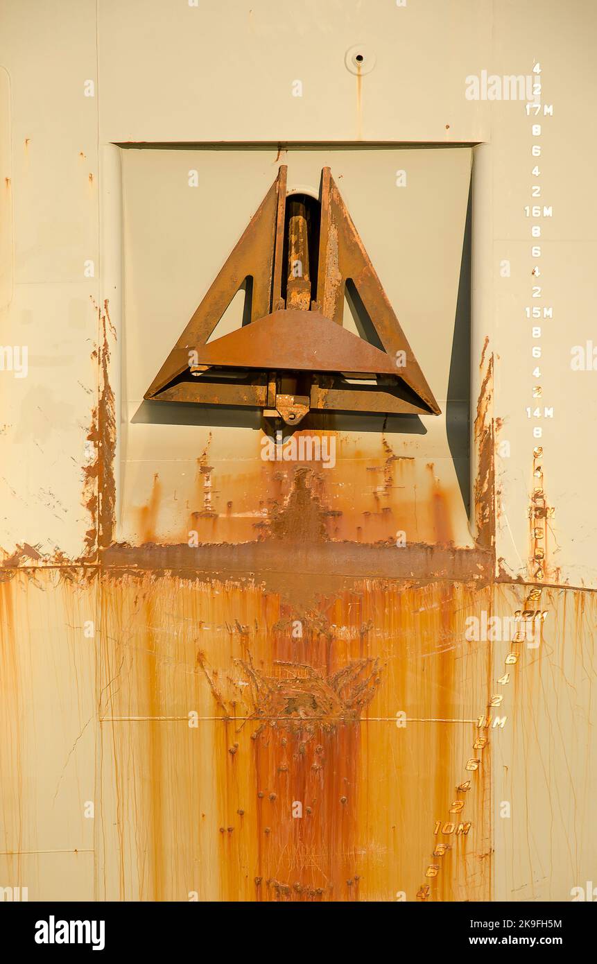 Rusty triangular anchor in its enclosure on the hull of an old ship ...