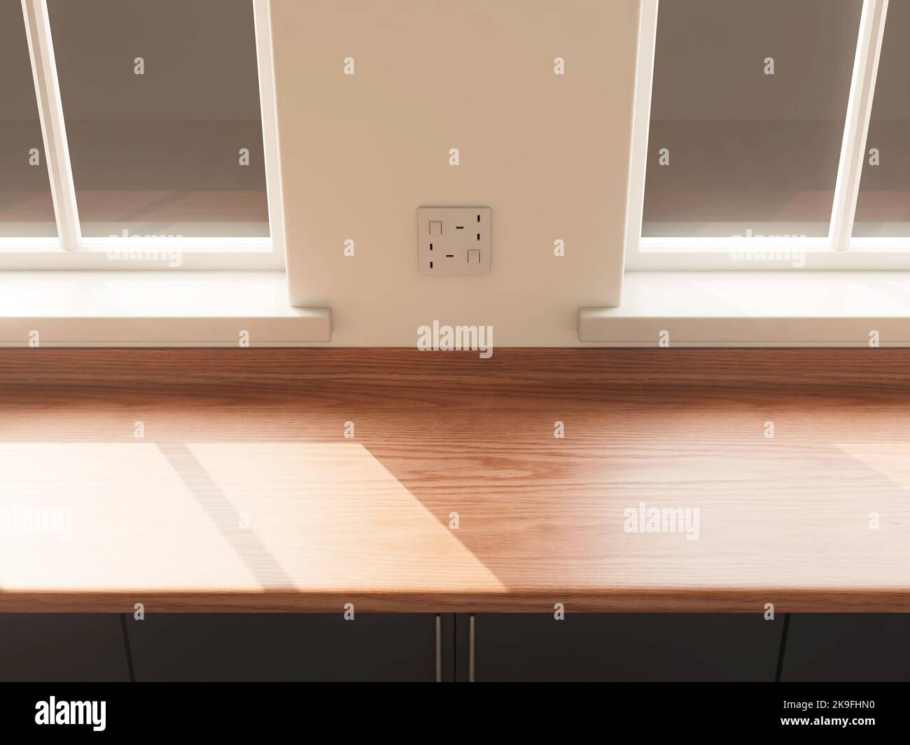 A closeup view of an empty wooden kitchen countertop facing two windows ...