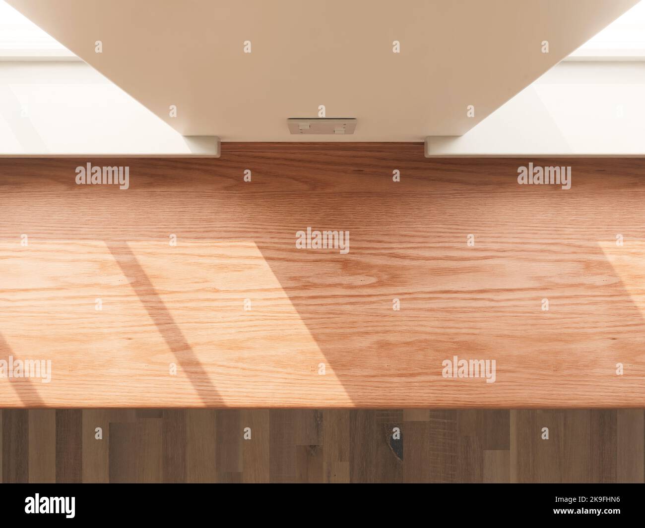 A closeup view of an empty wooden kitchen countertop facing two windows ...
