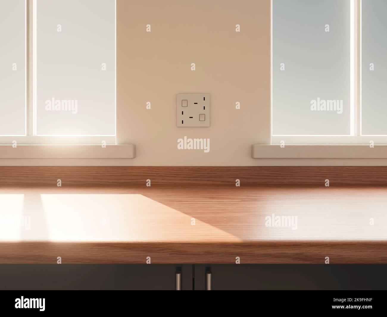 A closeup view of an empty wooden kitchen countertop facing two windows ...