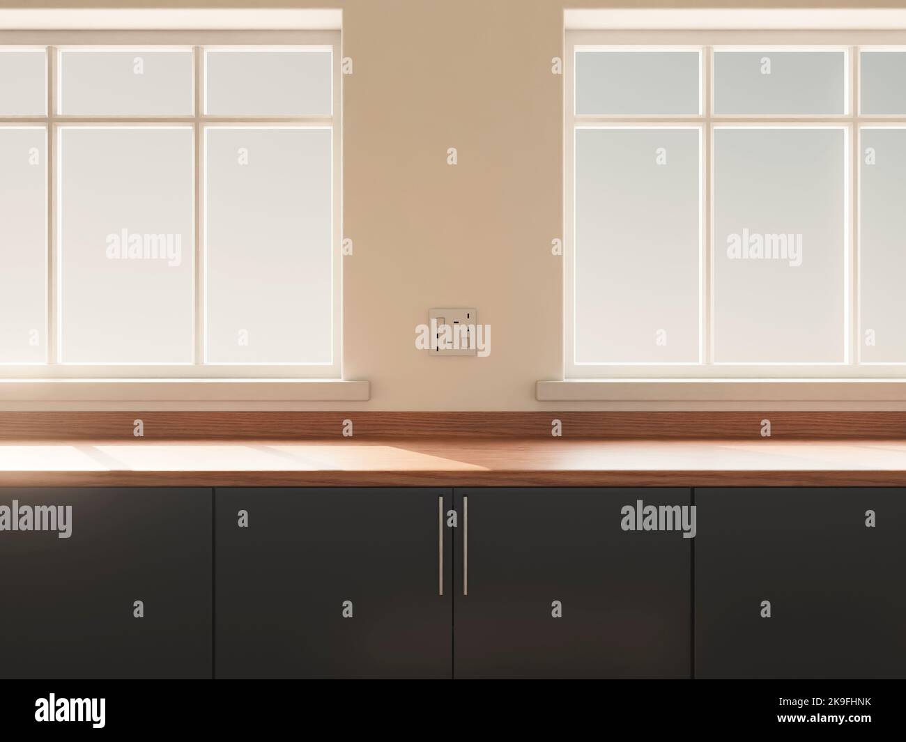 A closeup view of an empty wooden kitchen countertop facing two windows ...