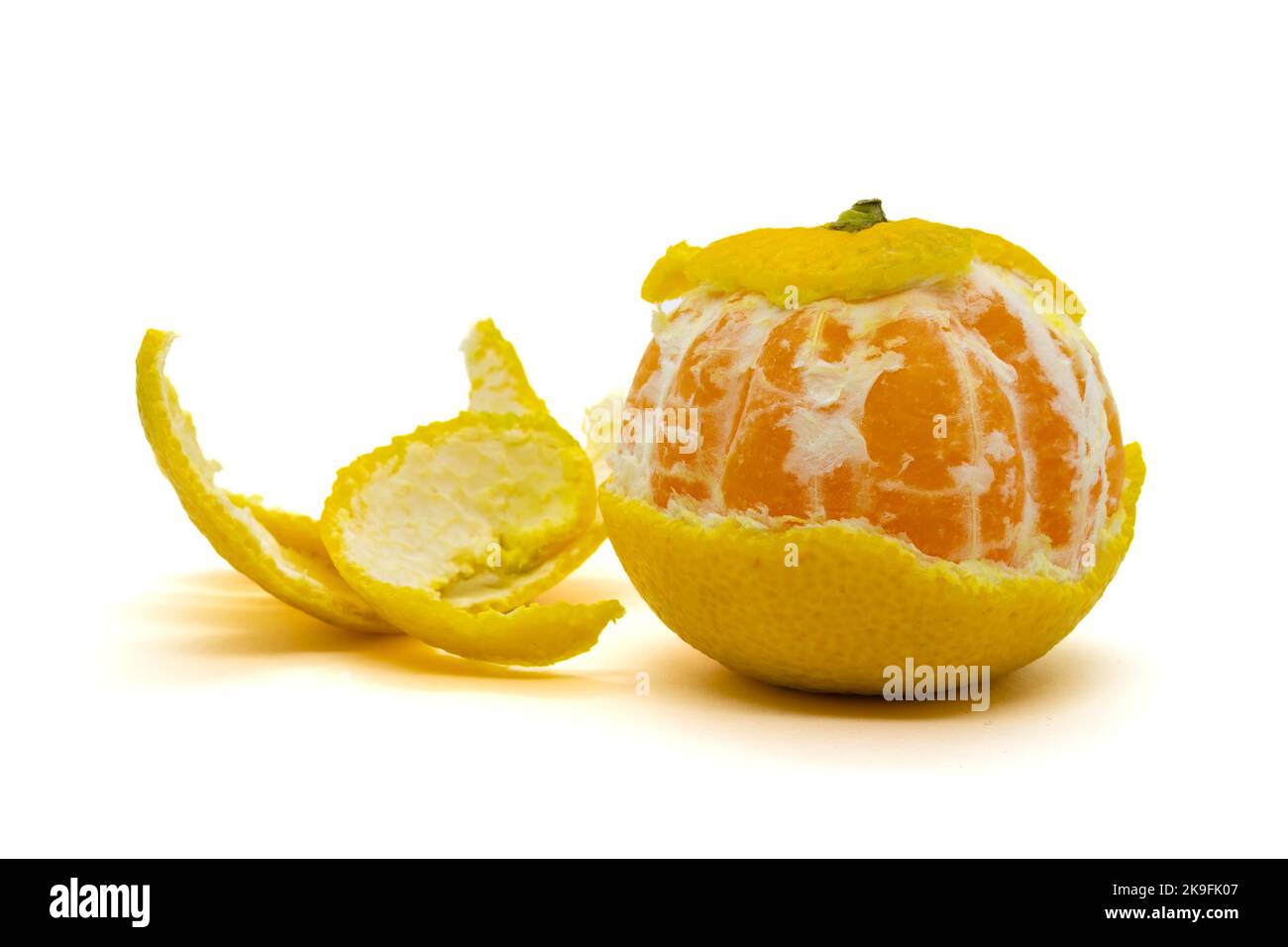 Ripe yellow half-peeled satsuma orange (Citrus unshiu) isolated on ...