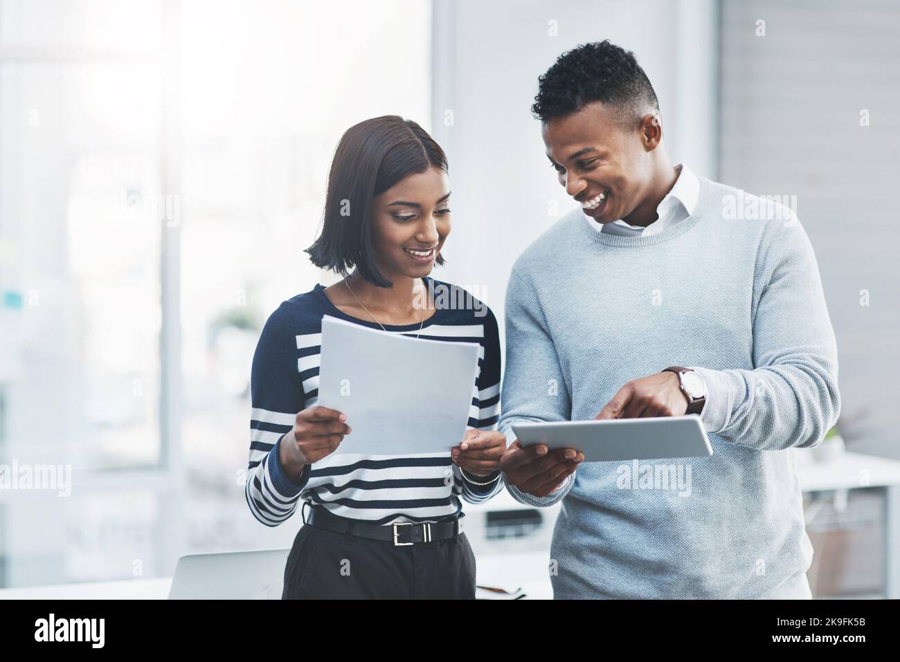 Teamwork clearly makes the dream work. two young businesspeople ...