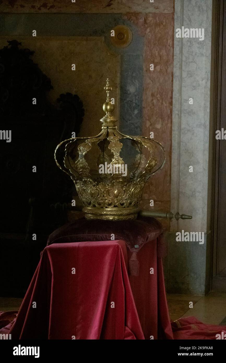 MAFRA, PORTUGAL - 29th JUNE 2022: Royal golden crown over a red cloth ...