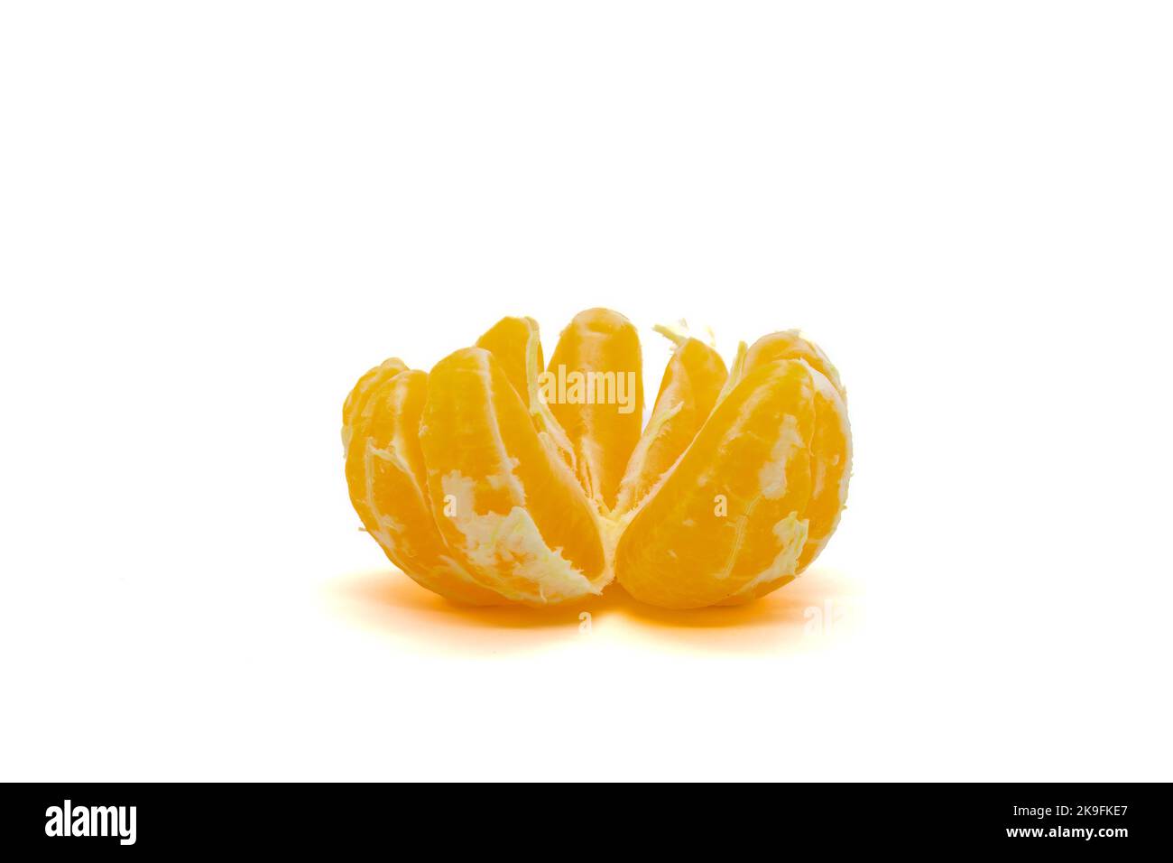 Ripe yellow peeled and sliced satsuma orange (Citrus unshiu) isolated ...