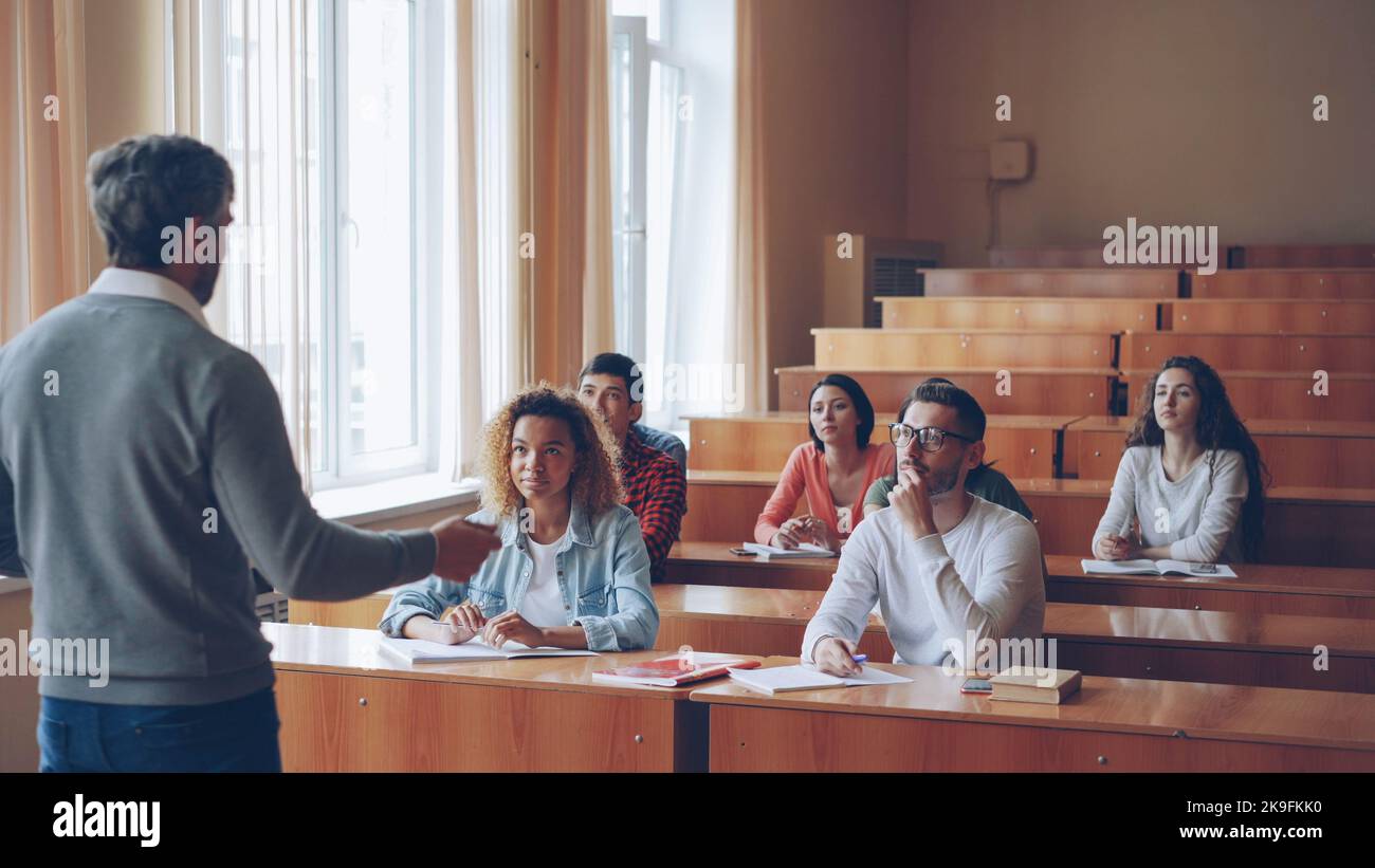 Multi-ethnic group of students is answering teacher's questions, smart ...
