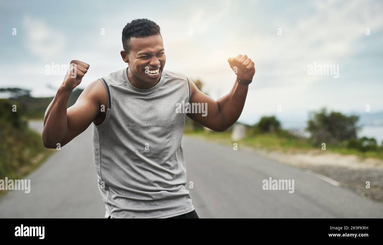 I did it. a handsome young sportsman cheering in celebration outside ...