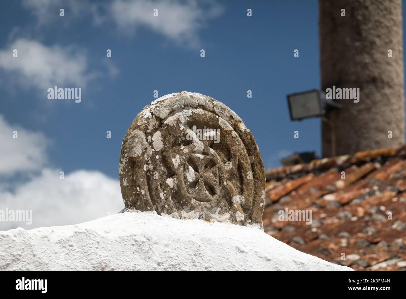 Close up view of a knights templar cross in stone on top of house in ...
