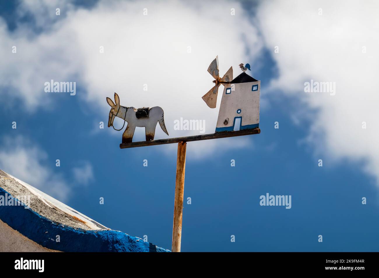 weather or wind vane indicator in the shape of a donkey and mill Stock ...