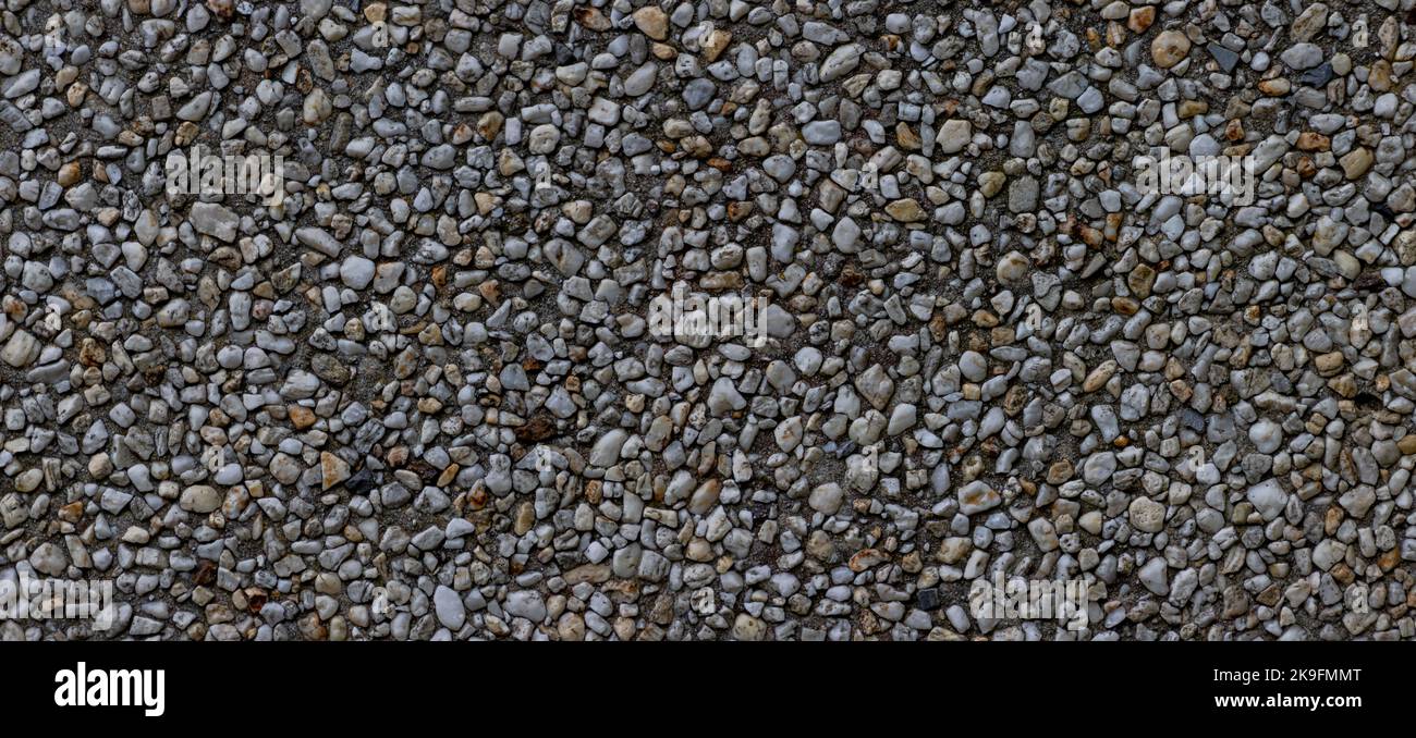 Panorama of small pebbles in concrete wall for background Stock Photo ...