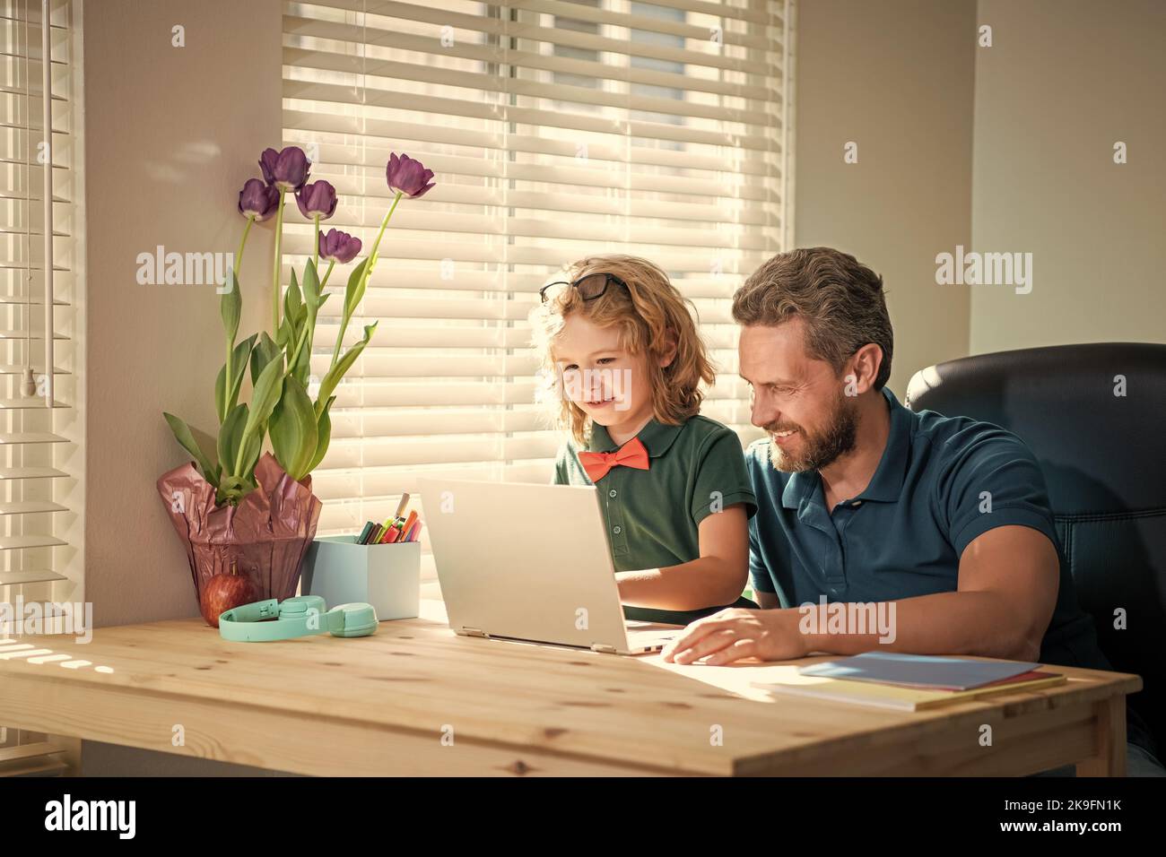 happy daddy or teacher helping his school son kid in glasses study with ...