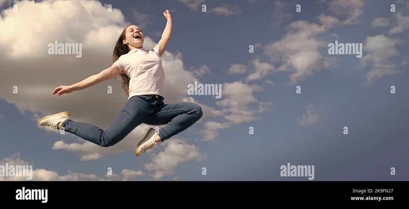 happy teen child jump on sky background. Horizontal poster of isolated ...