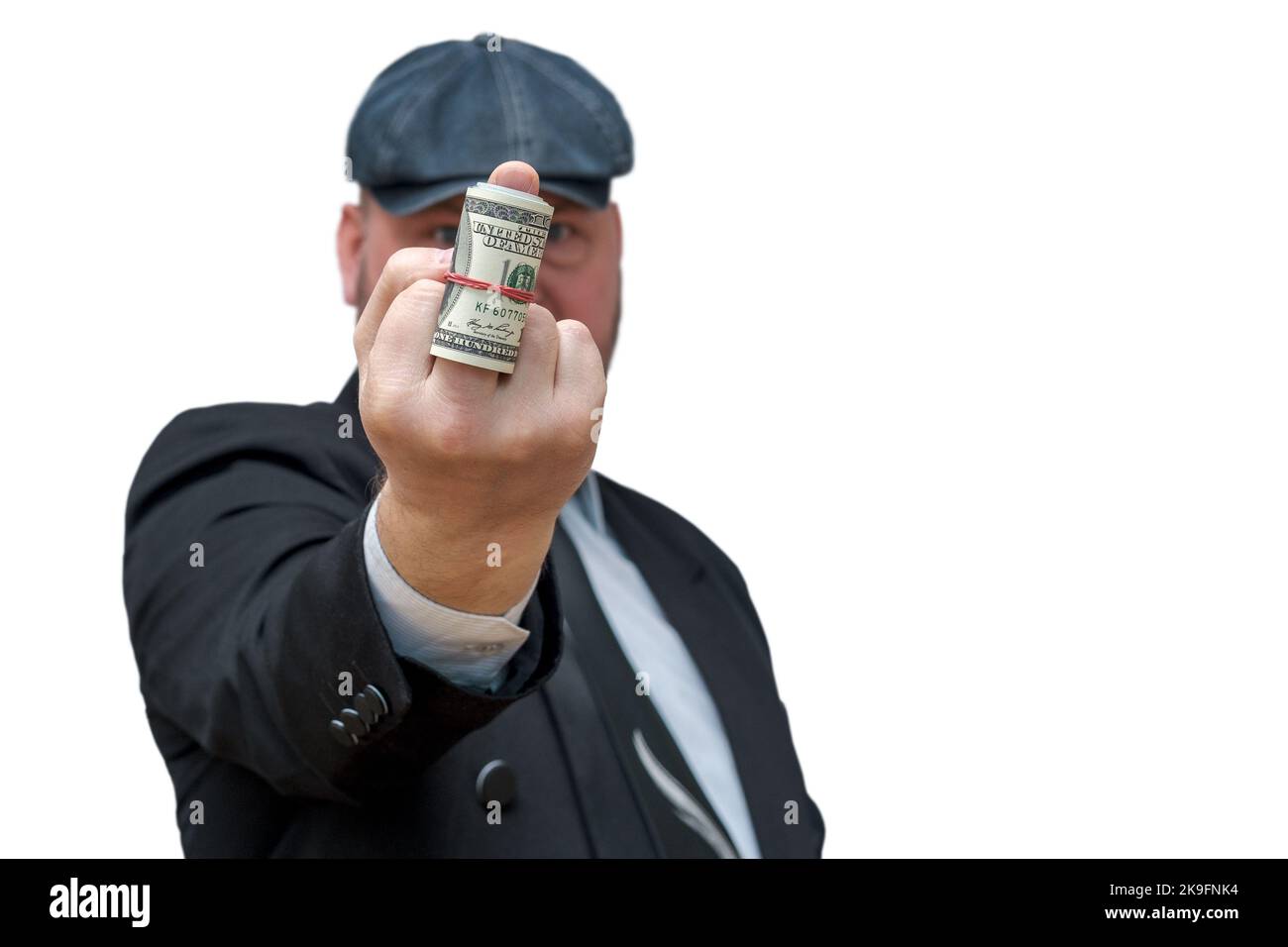 A man shows the middle finger on which dollars are rolled up into a ...