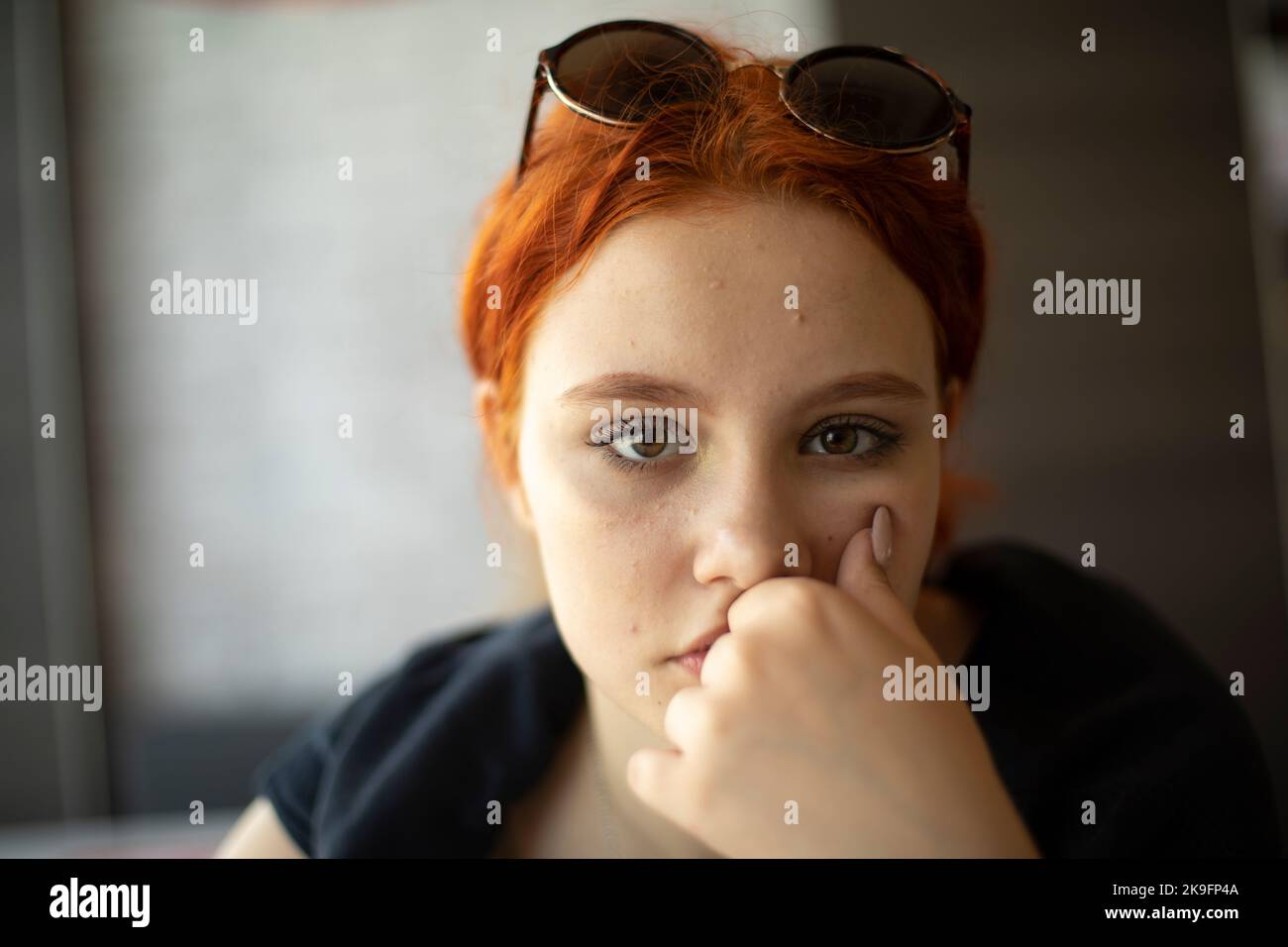 Girl looks into camera with serious look. Young girl thinks. Woman's ...