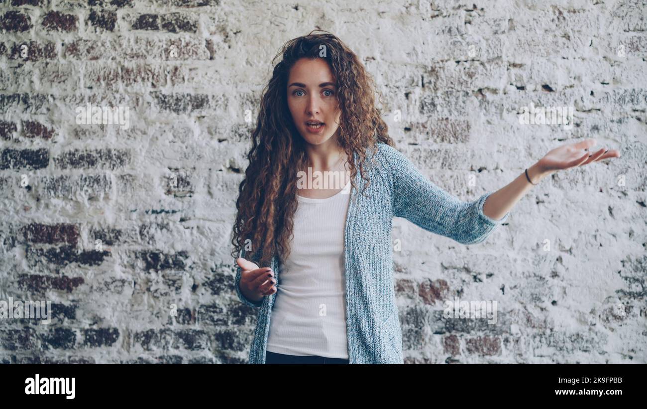 Portrait of angry young woman talking and gesturing expressing negative ...