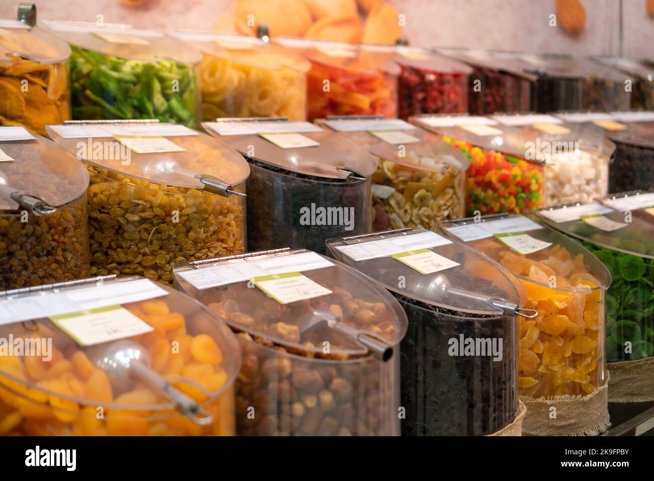 Assorted dried fruits in plastic containers in the store close-up Stock ...