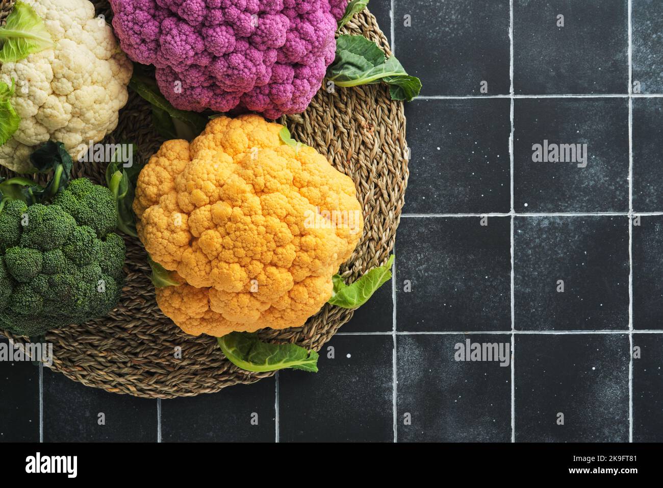 Colorful cauliflower. Various sort of cauliflower on old stone tiles ...