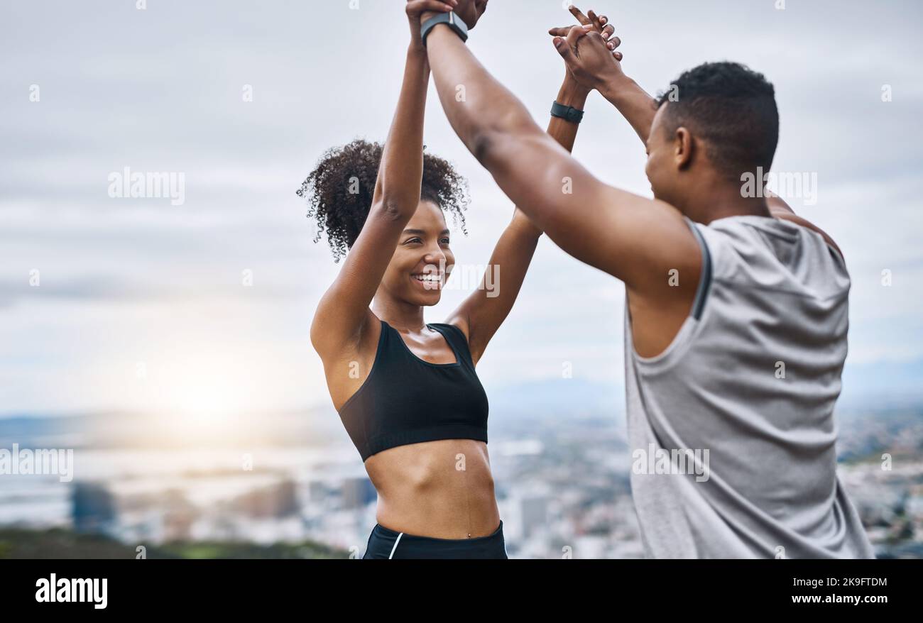 I feel as amazing as you do. a sporty young couple high fiving each ...
