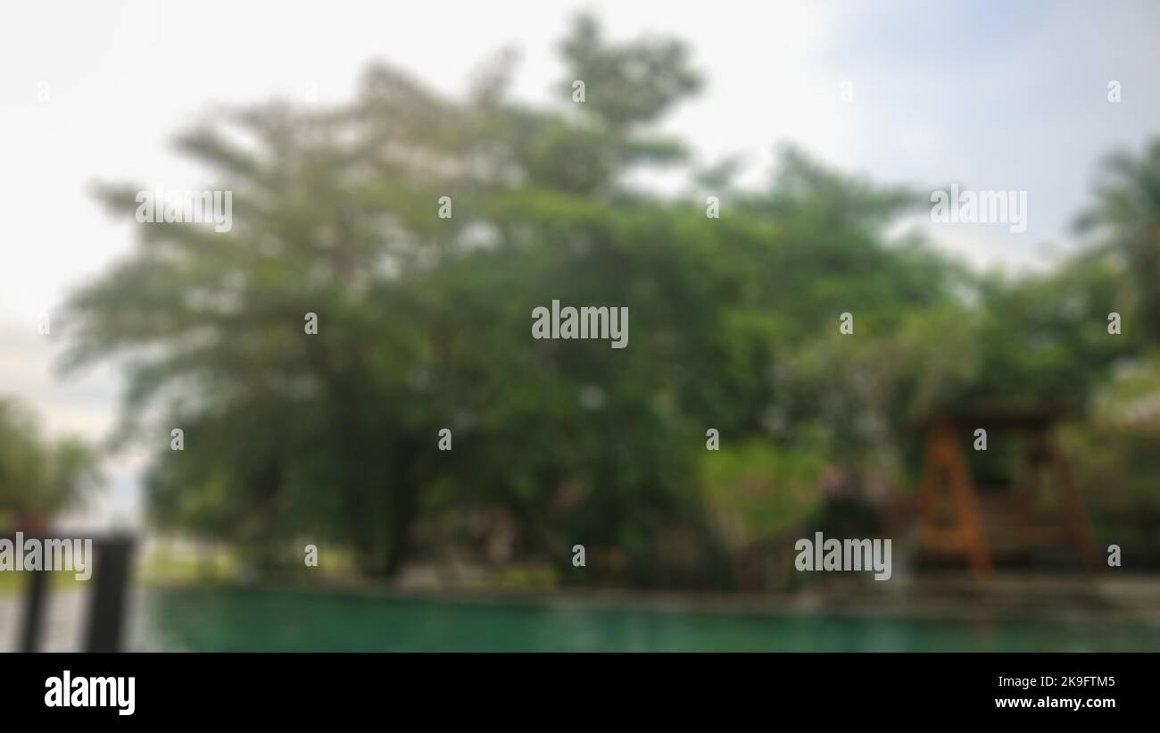 blurry swimming pool, beautiful trees and cloudy sky Stock Photo - Alamy