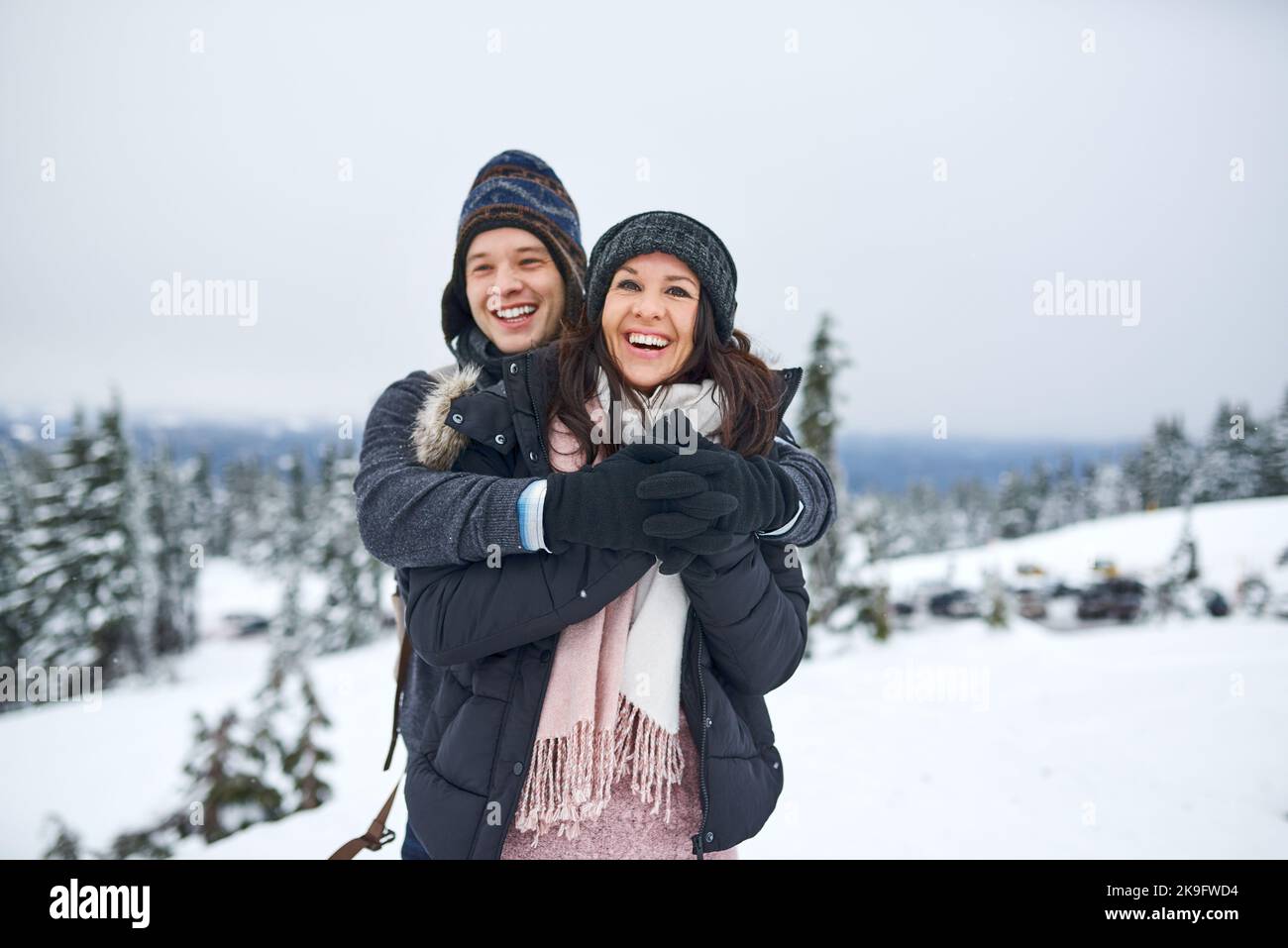 The best time to cuddle is in winter. a happy young couple enjoying ...