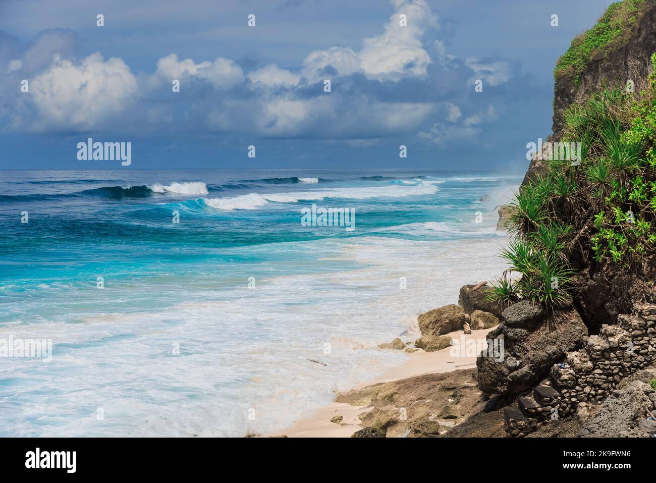 Tropical beach with big blue ocean waves in Bali island Stock Photo - Alamy