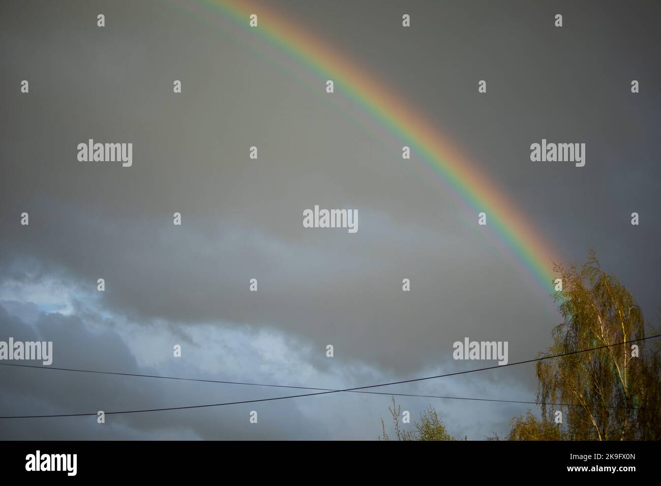 Rainbow in sky. Beautiful weather. Decomposition of light into colors ...