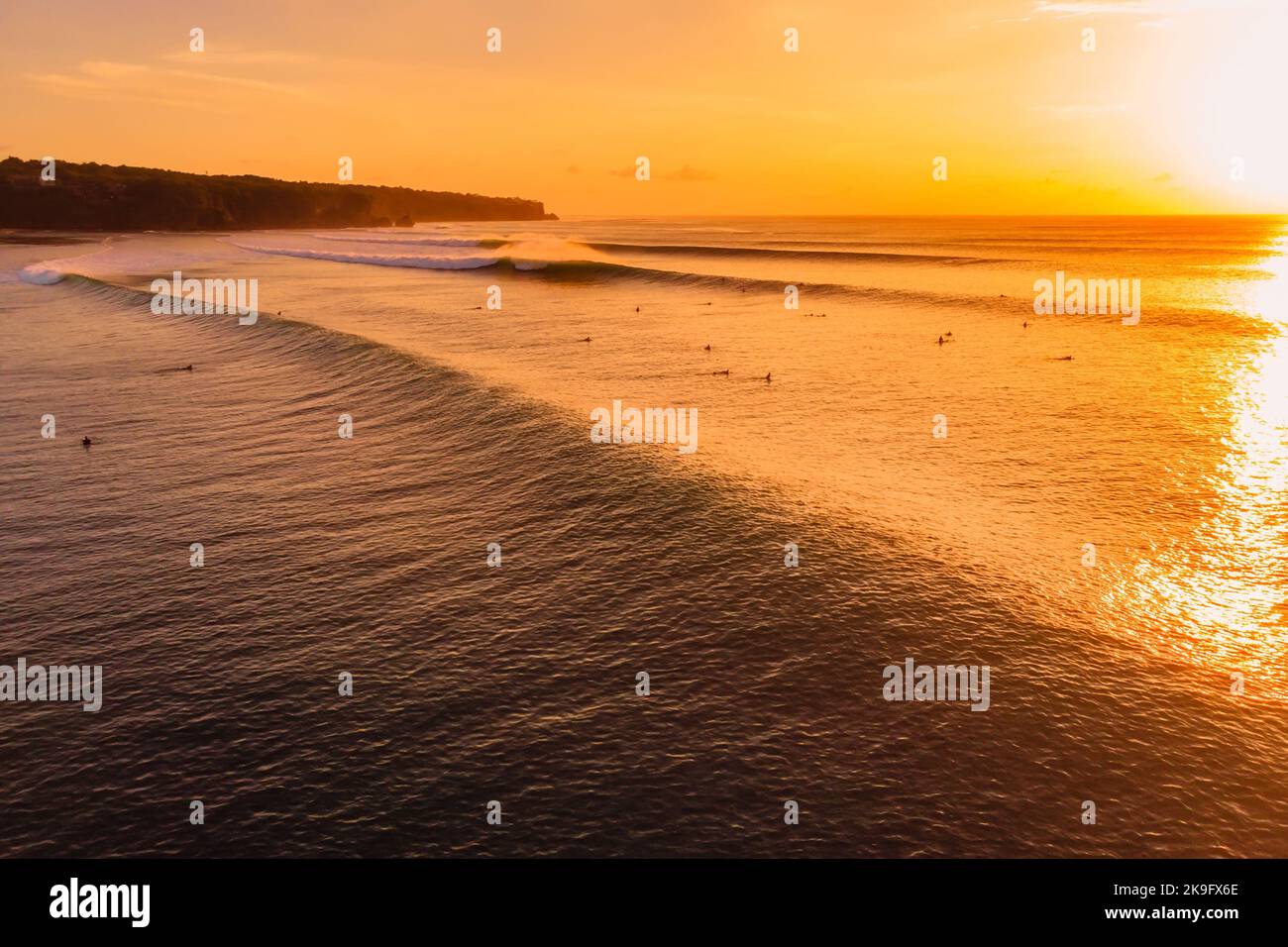Aerial view of surfing waves at warm sunset. Perfect swell lines in ...