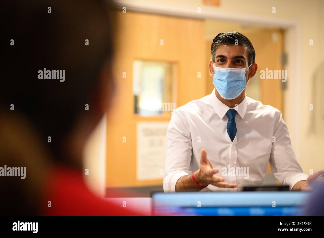 Prime Minister Rishi Sunak speaks with members of staff during a visit ...
