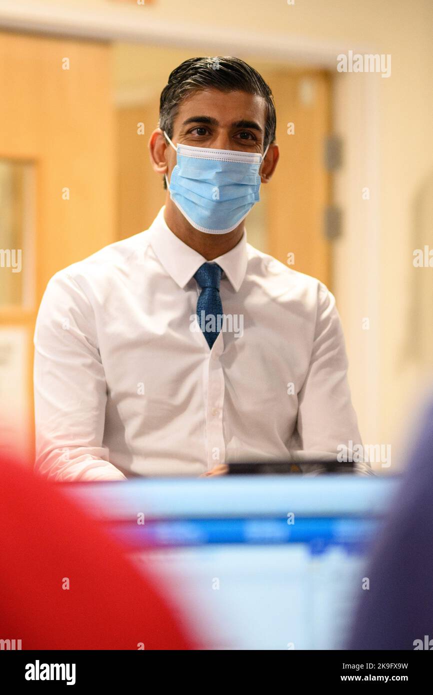 Prime Minister Rishi Sunak speaks with members of staff during a visit ...