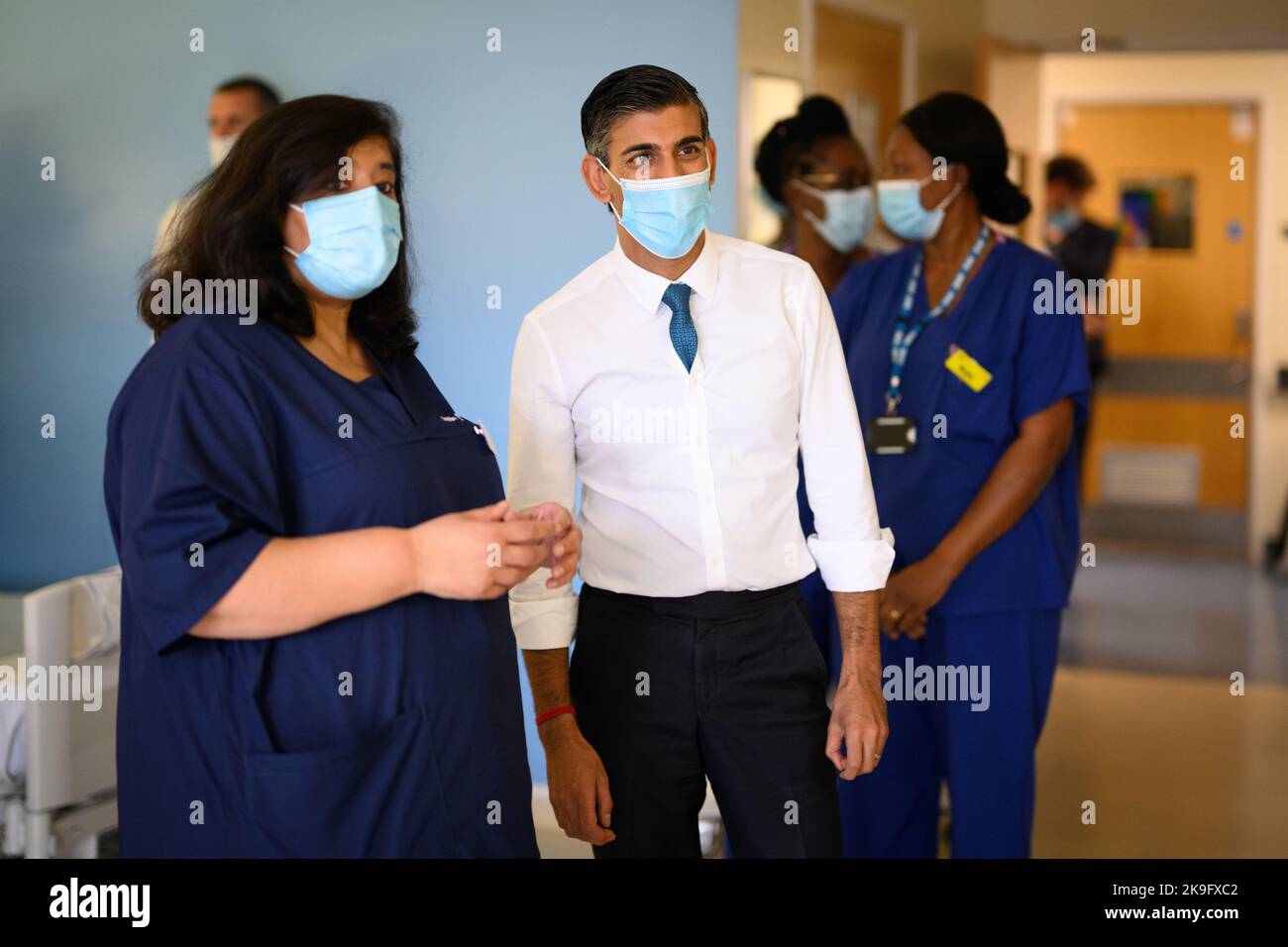 Prime Minister Rishi Sunak speaks with members of staff during a visit ...