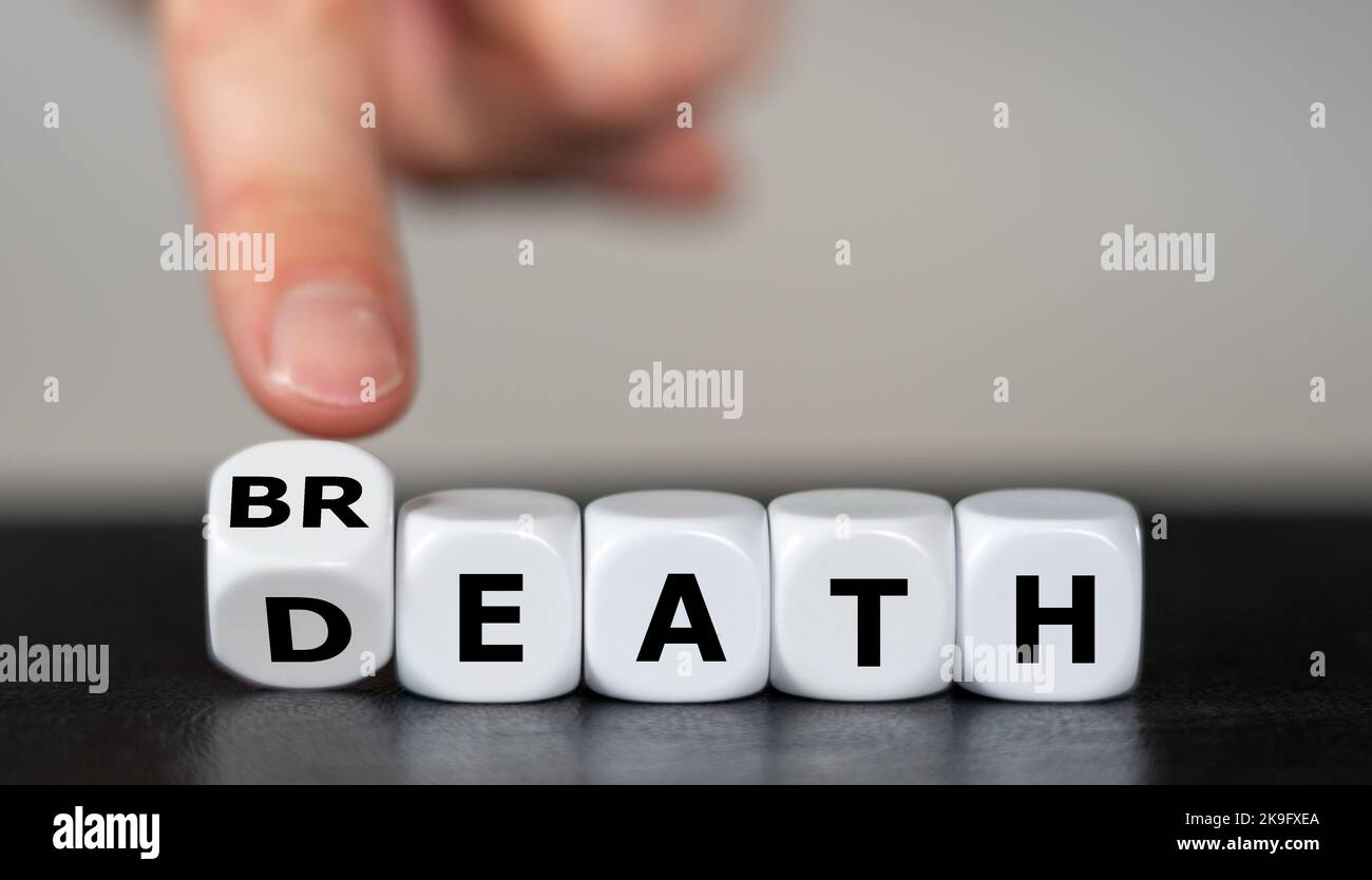 Hand turns dice and changes the word death to breath. Symbol for ...