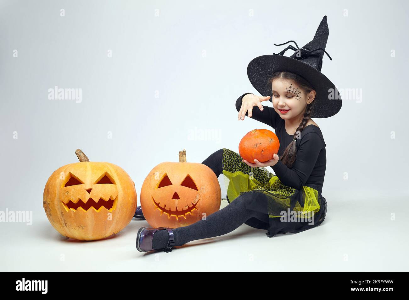 portrait of a charming little girl in a witch costume, Jack's lamps are ...