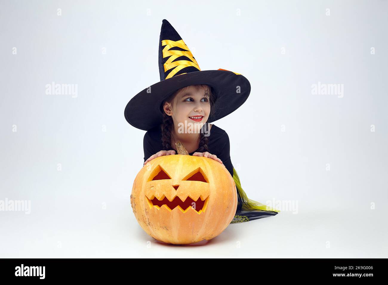 portrait of a charming little girl in a witch costume, Jack's lamps are ...