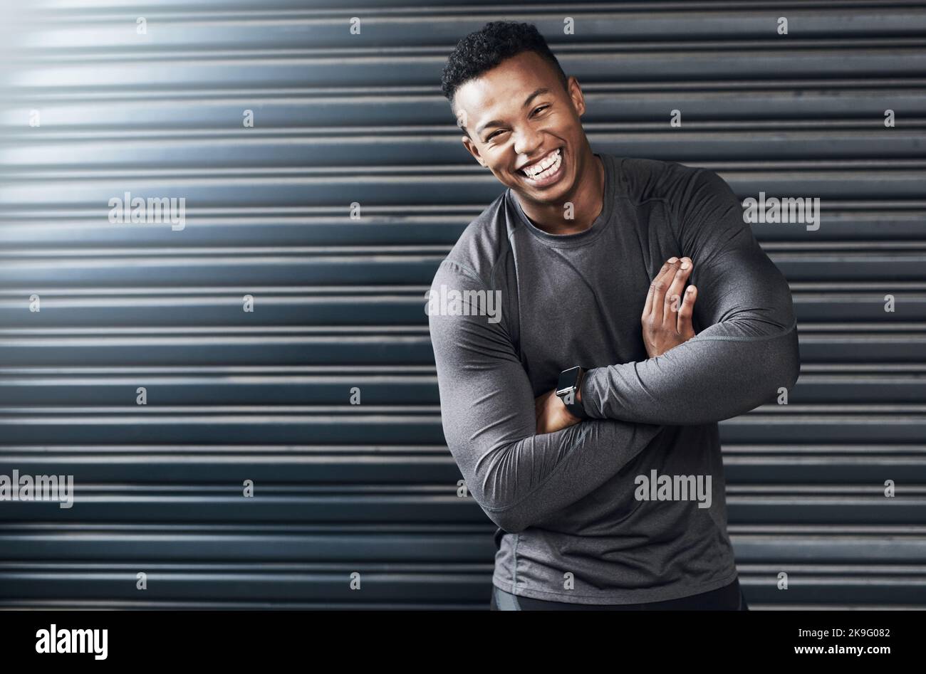 Do it firstly for yourself. Portrait of a sporty young man standing ...