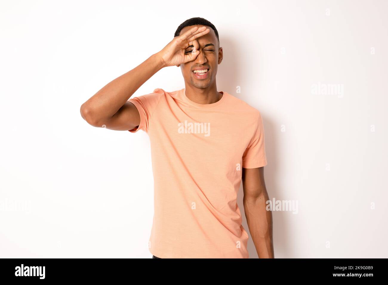 Young african black man showing okay sign over eye standing isolated ...