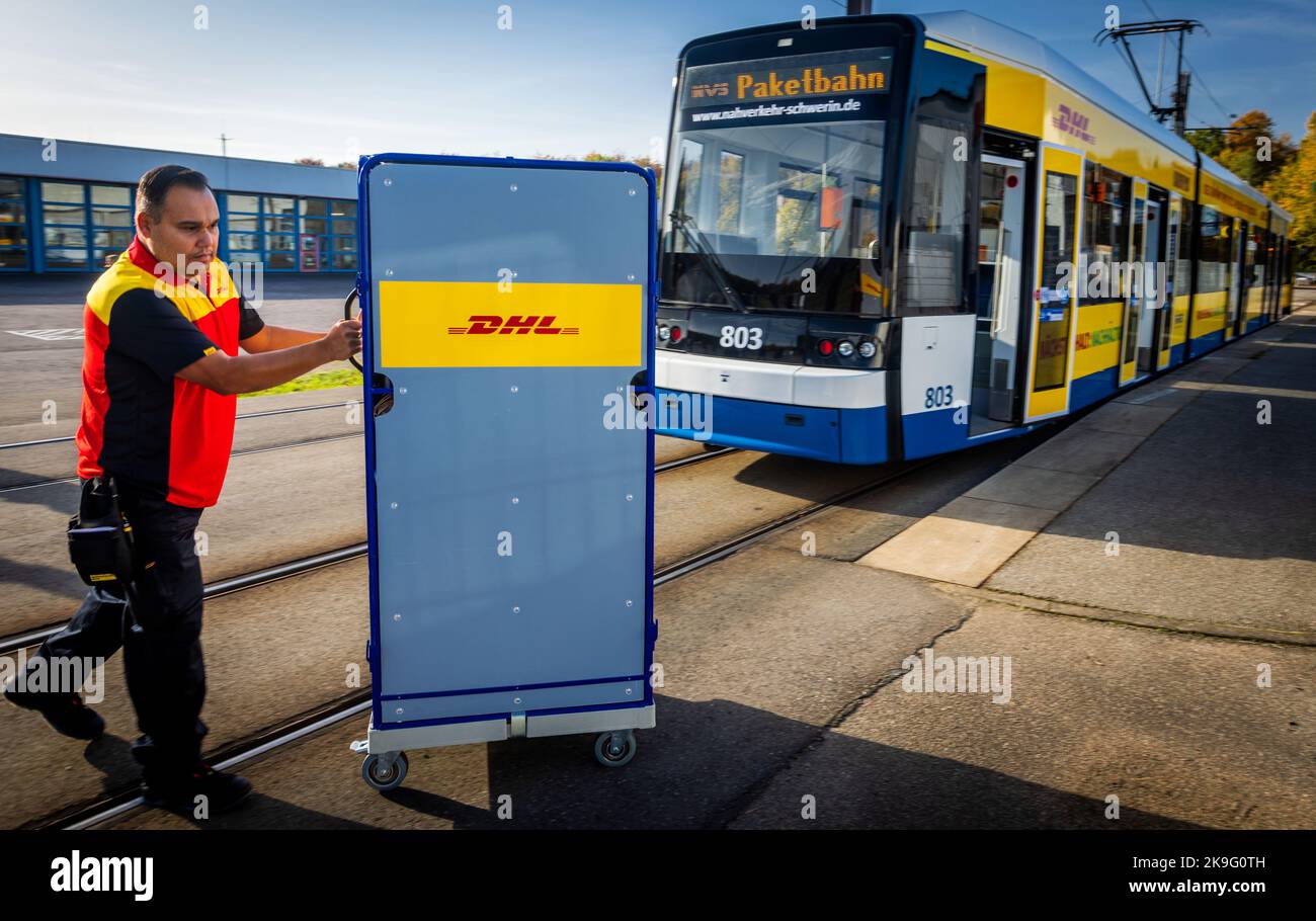 Schwerin, Germany. 28th Oct, 2022. A Deutsche Post employee pushes a ...