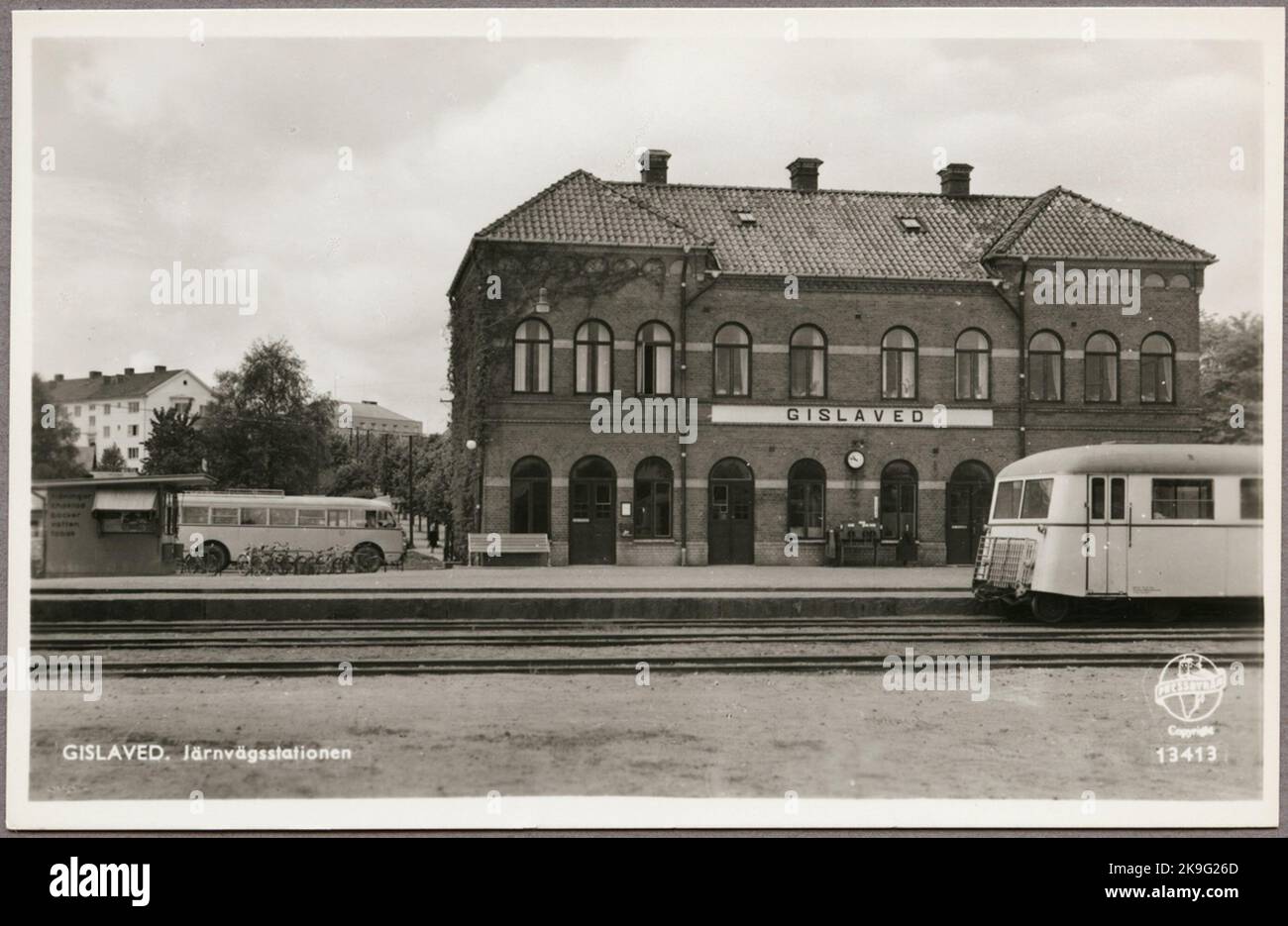 Track side of station with rail bus at platform and buildings in the ...