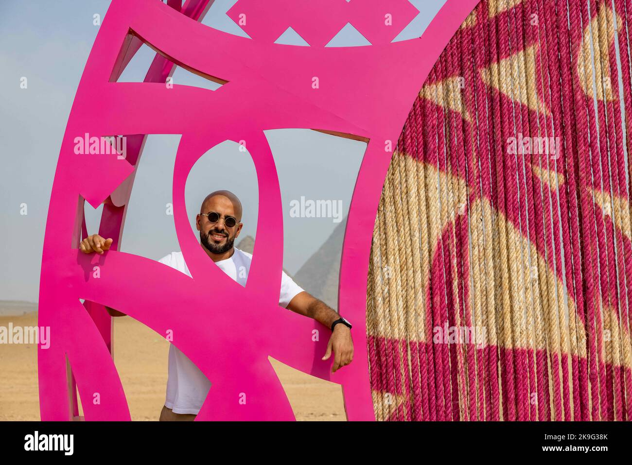 Tunisian-French artist eL Seed, poses next to his artwork, entitled ...