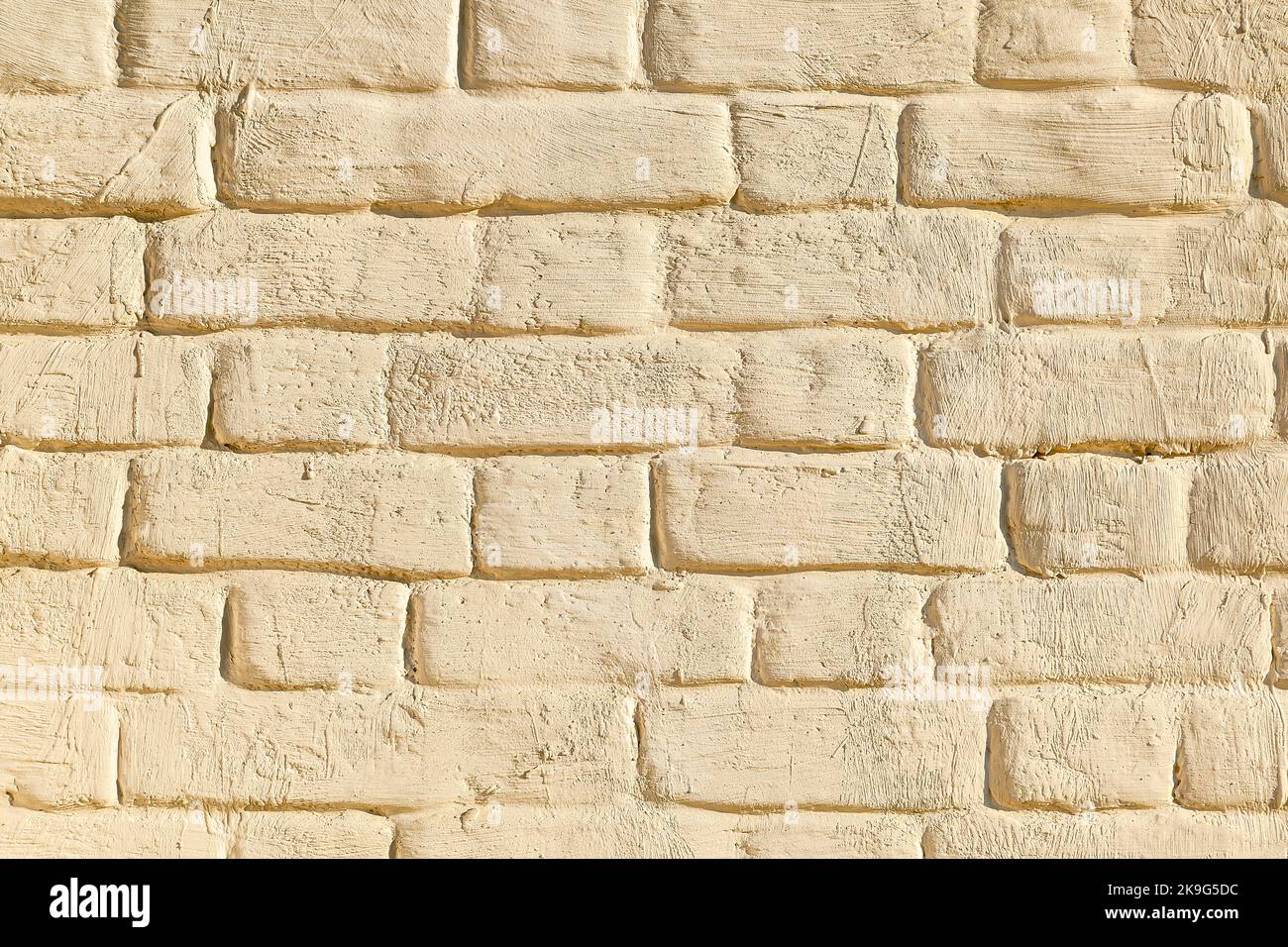Brick wall with biege plaster texture background Stock Photo - Alamy