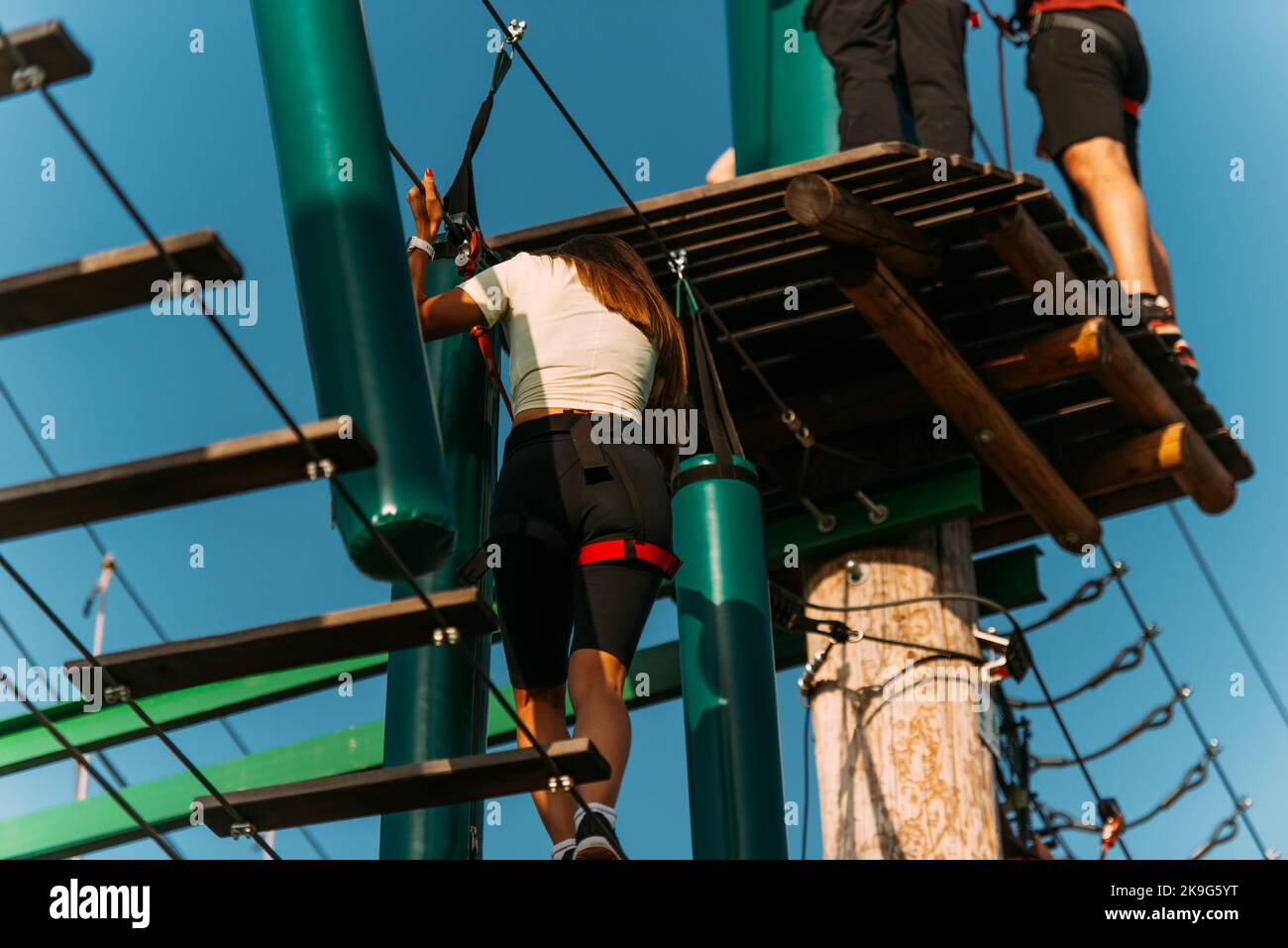 Team of skilled climbers preparing to do the hardest obstacle of them ...