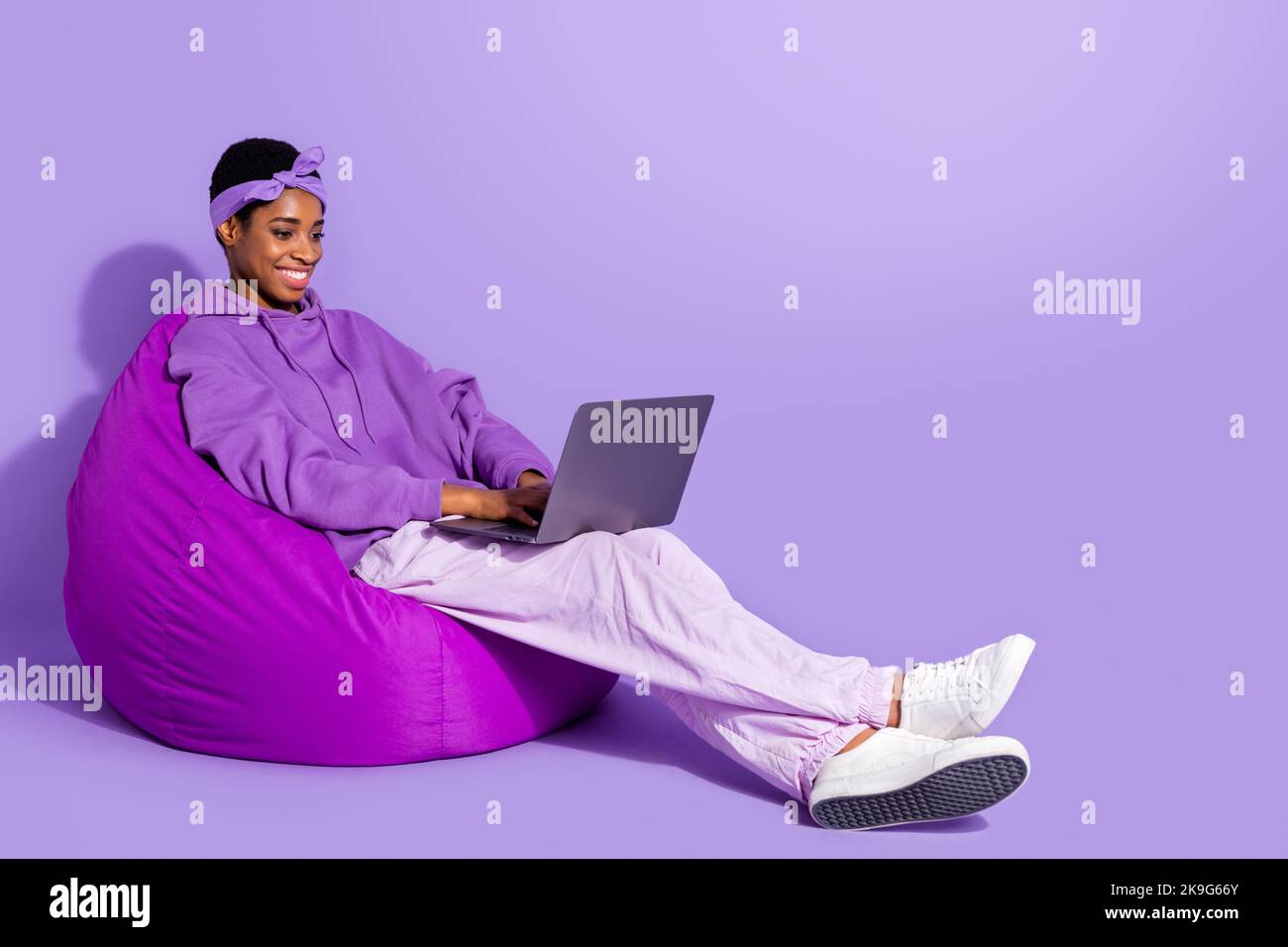 Photo of freelancer programmer transgender sit bean bag typing pc wear ...
