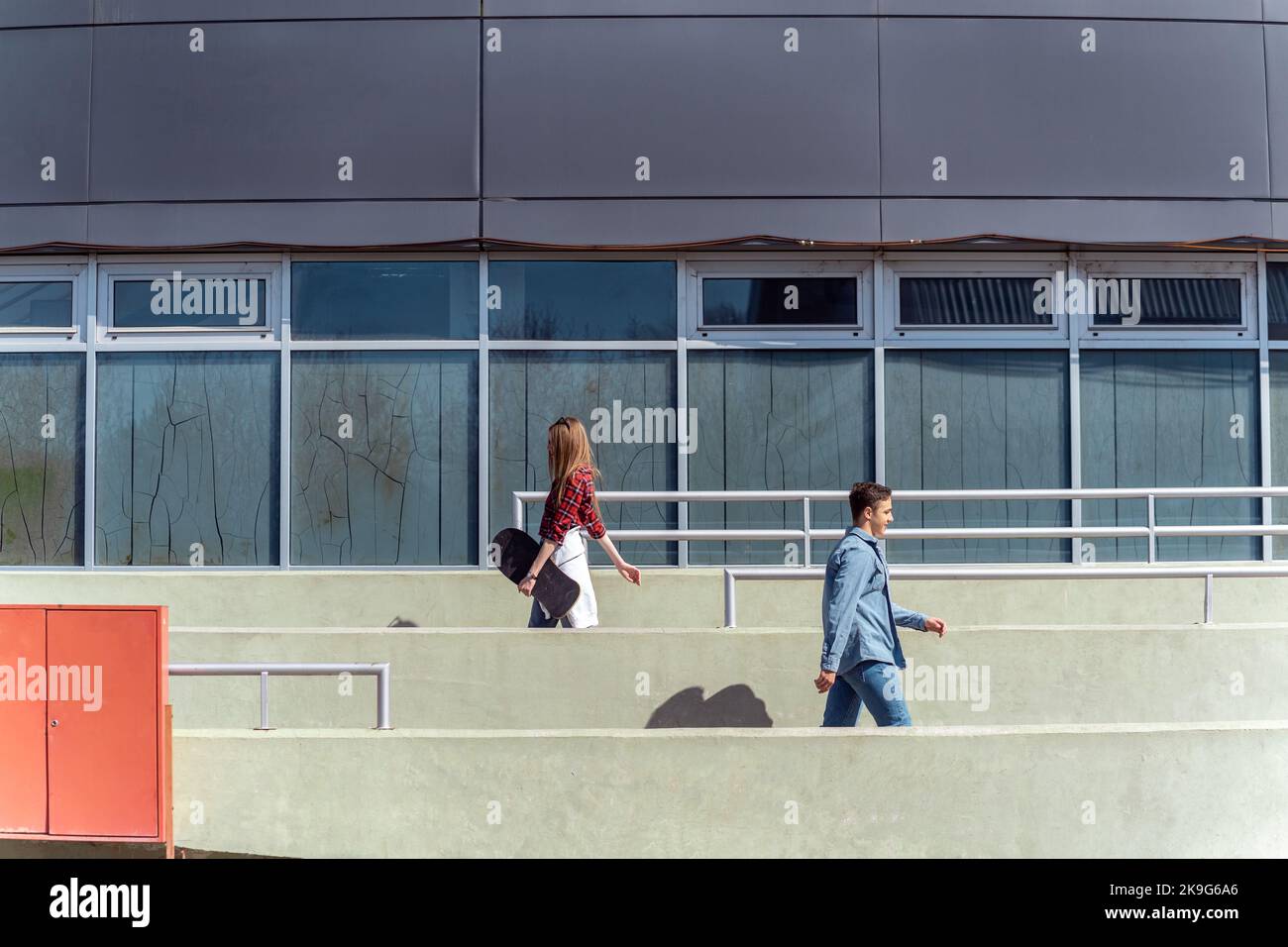 Boy and girl walking between the buildings Stock Photo - Alamy