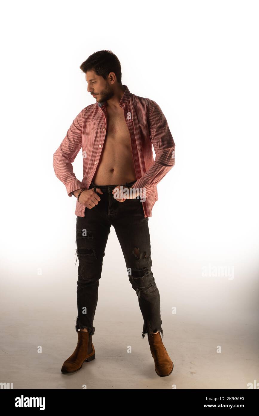 Handsome man making himself look good for the photoshoot in the studio ...