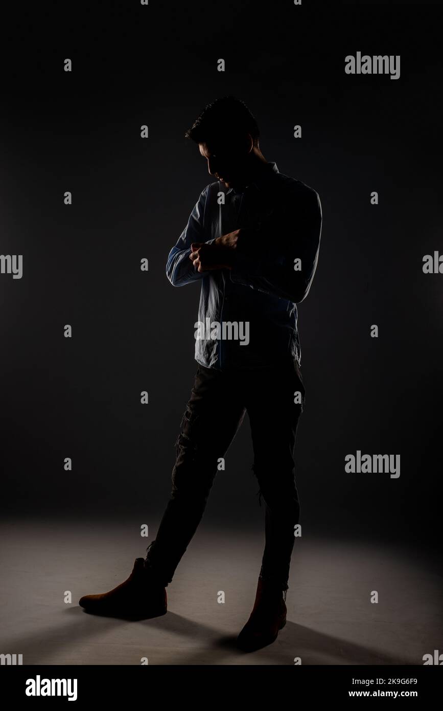 Attractive and handsome man in the studio setting himself up for the ...